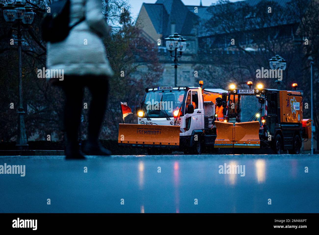 Hanover, Germany. 19th Dec, 2022. Two gritting vehicles spread grit on ...