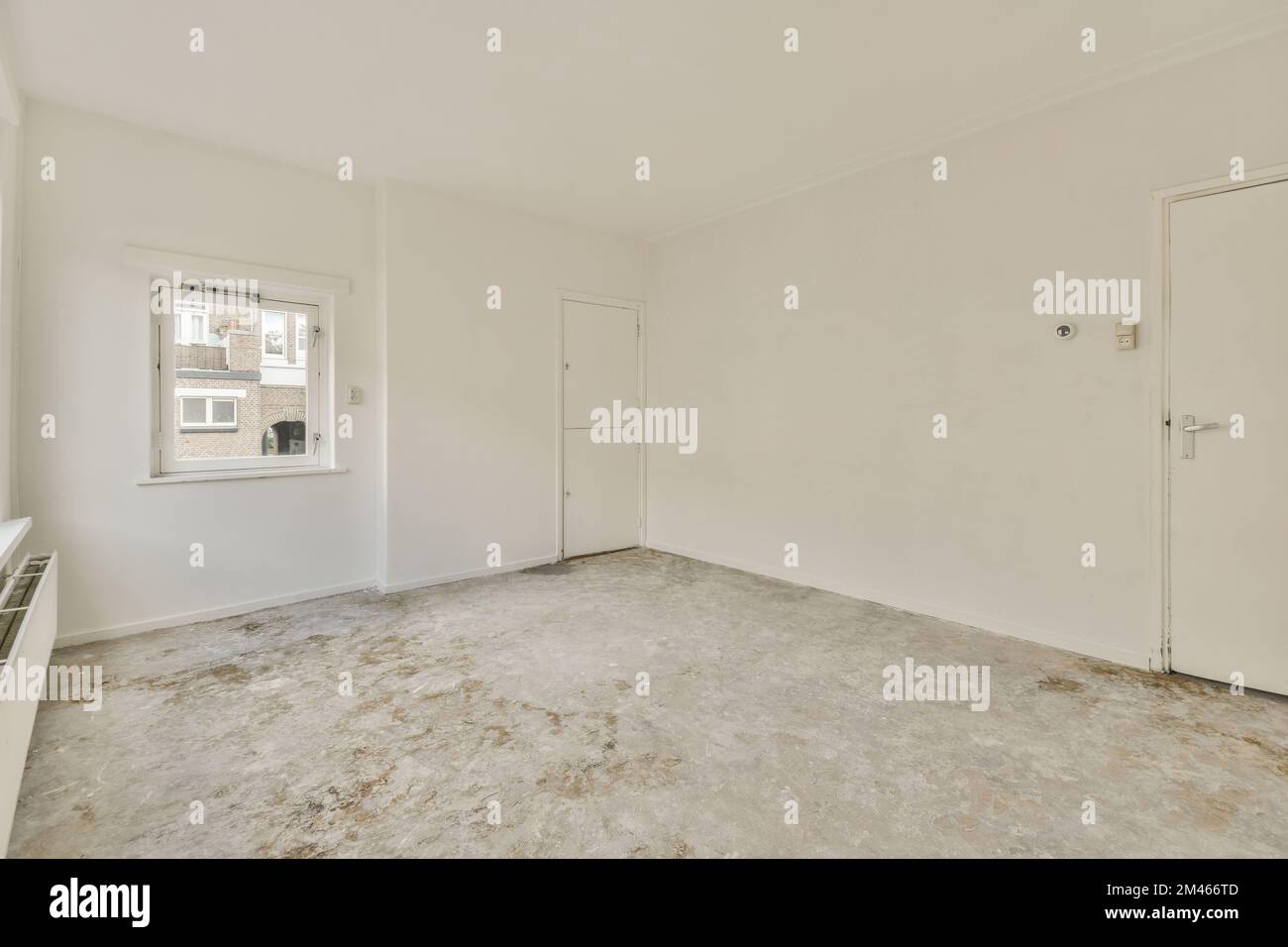 Plastic window and radiator on white wall in empty light room at home ...