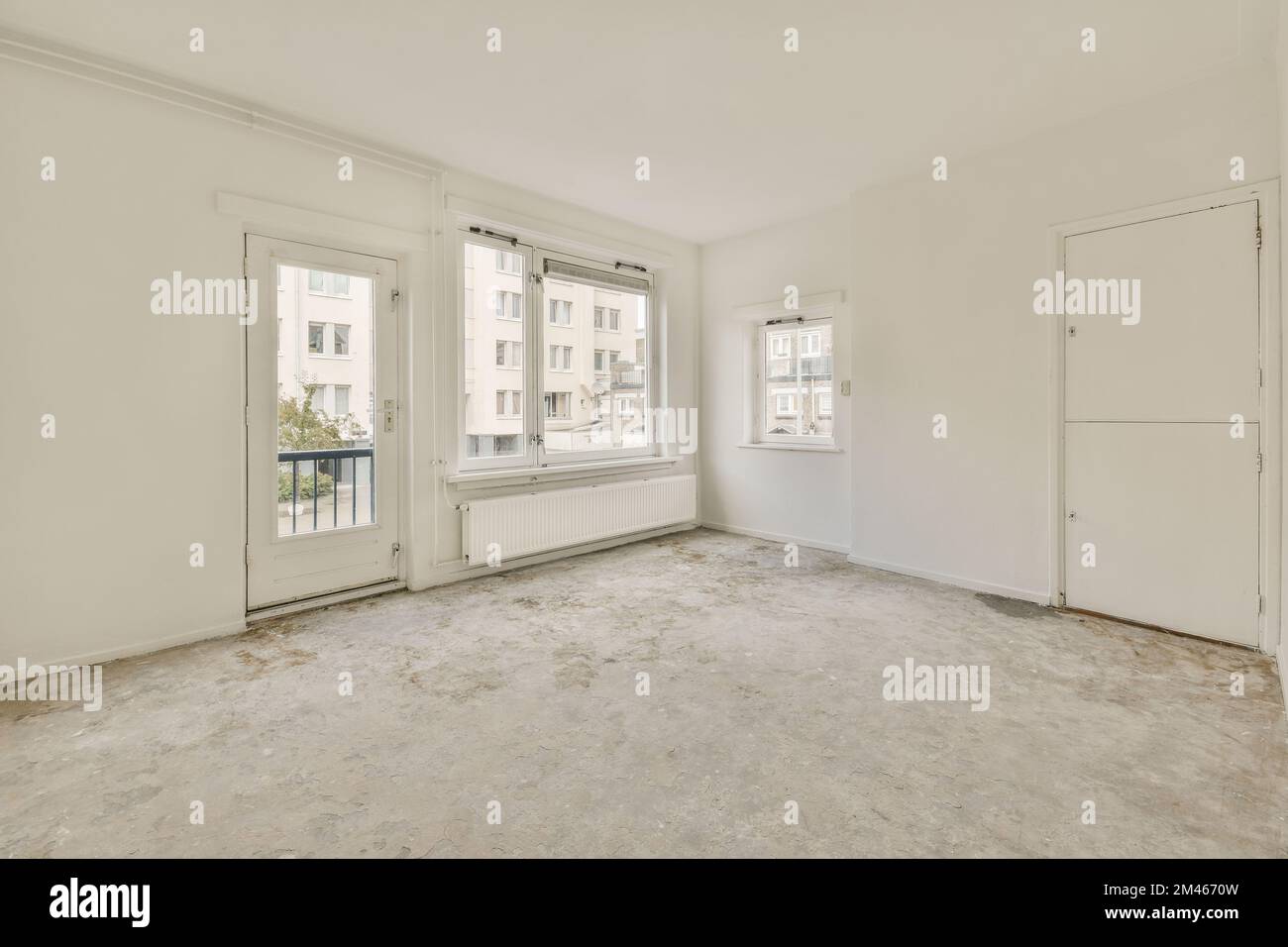 Plastic window and radiator on white wall in empty light room at home ...
