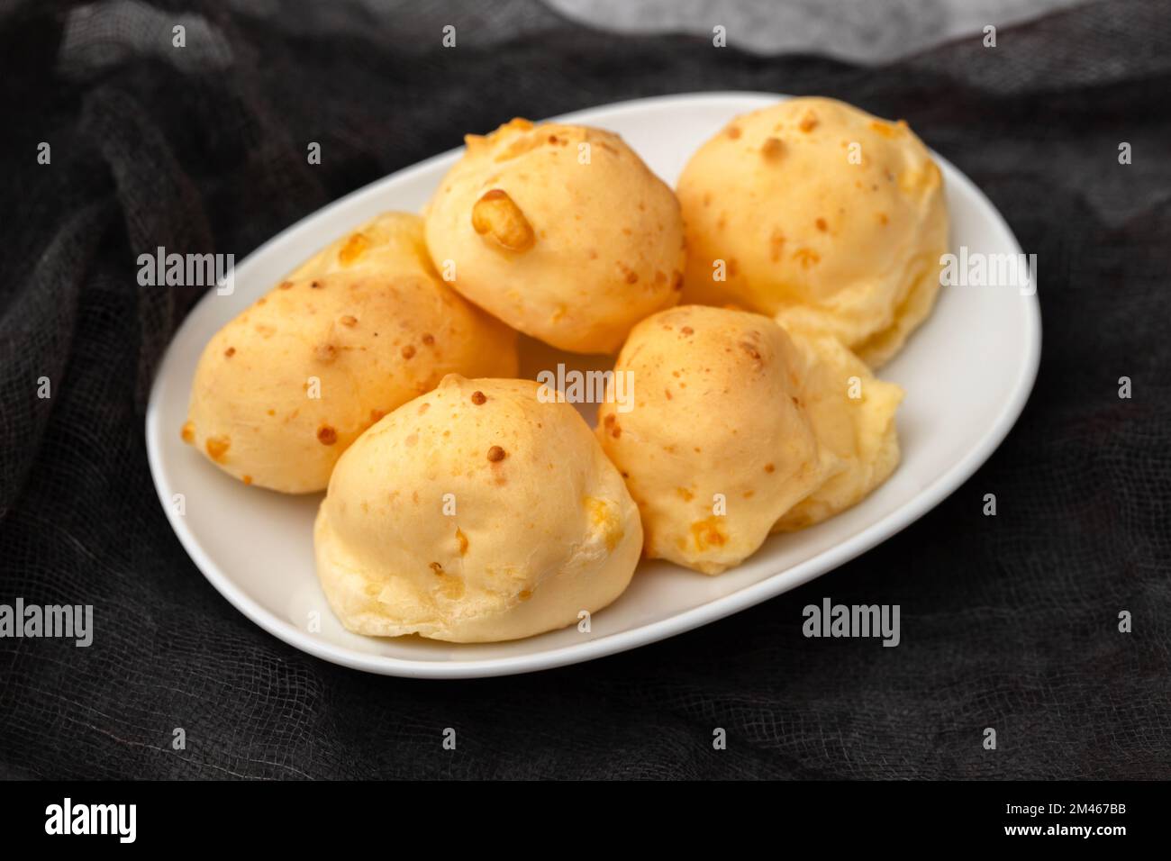 Brazilian snack pao de queijo cheese bread on white small dish Stock ...