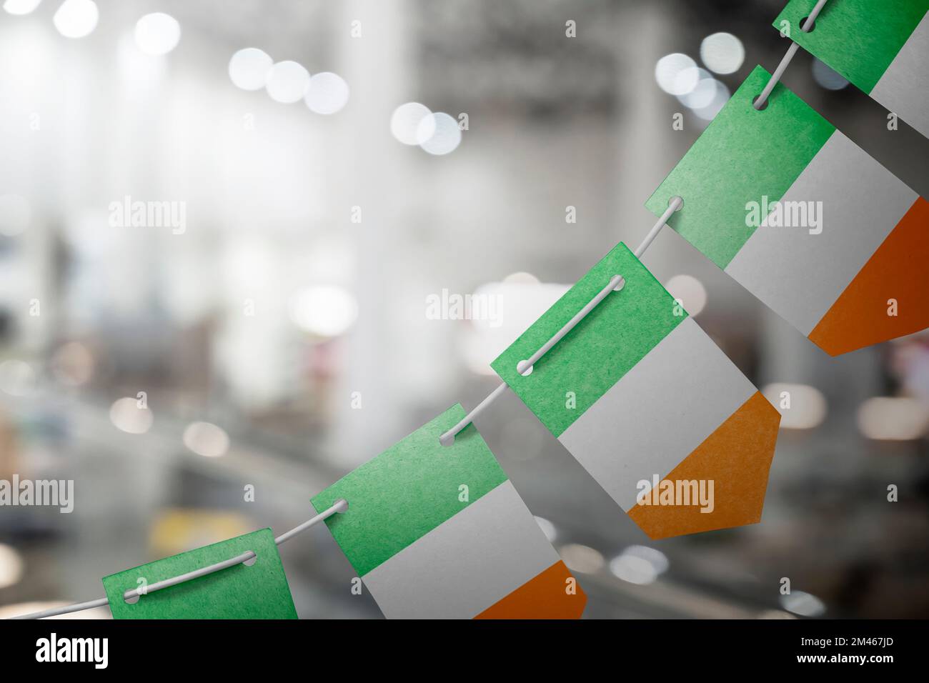 A garland of Ireland national flags on an abstract blurred background ...
