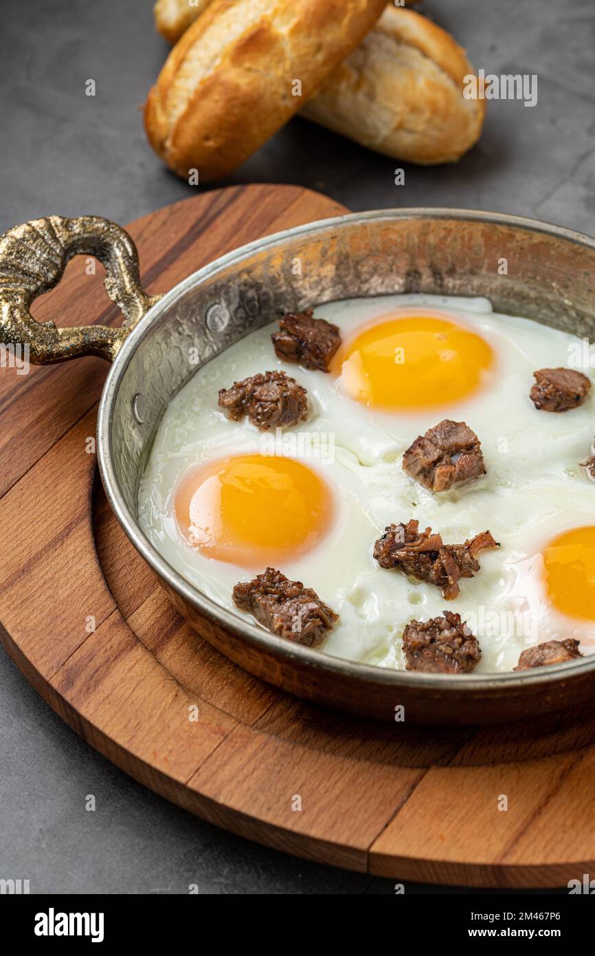 Turkish scrambled eggs Turkish name Kavurmali Yumurta with roasted meat in copper pan Stock ...