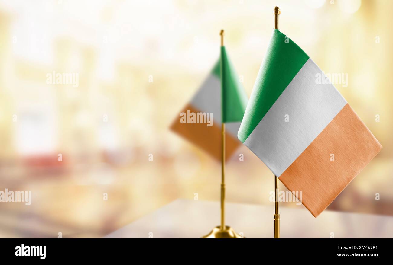 Small flags of the Ireland on an abstract blurry background Stock Photo ...