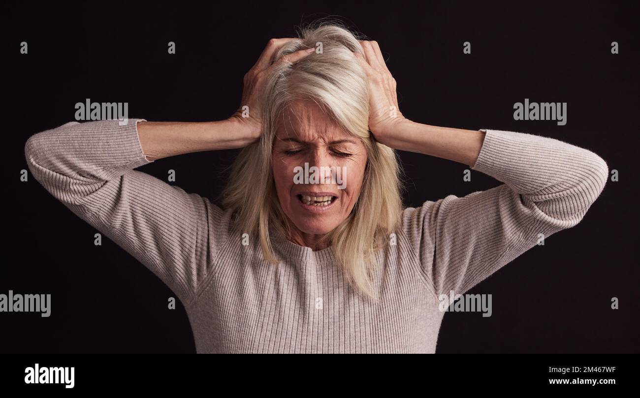 Senior woman, stress or anxiety on black background in studio in ...