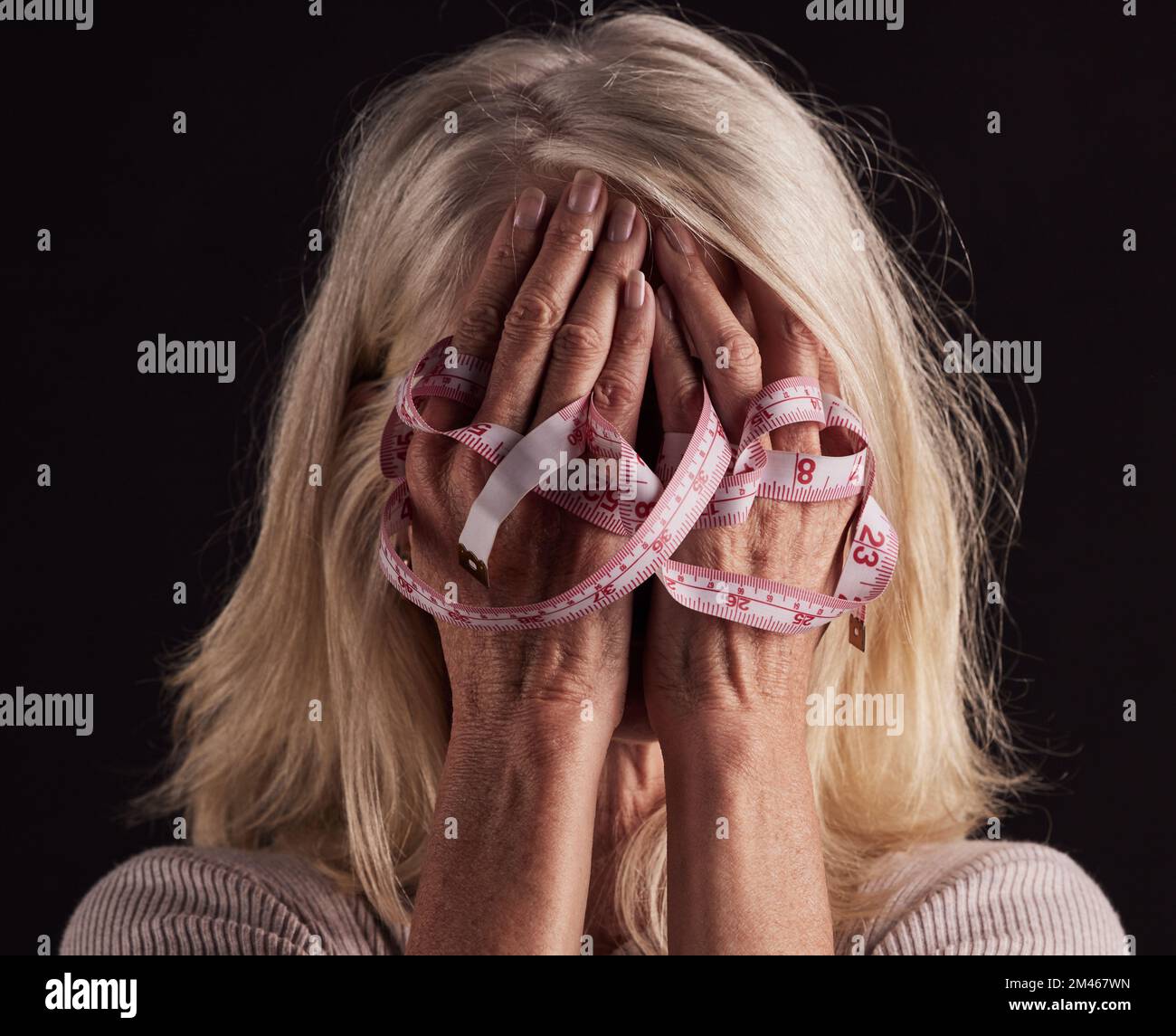 Hands, tape measure and anorexia with a woman holding her face in ...