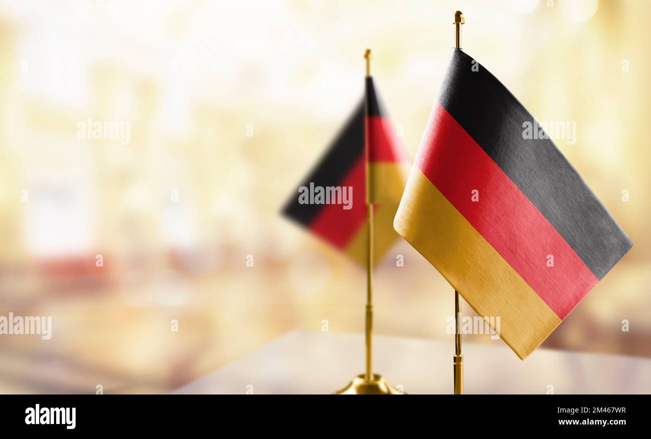 Small flags of the Germany on an abstract blurry background Stock Photo ...