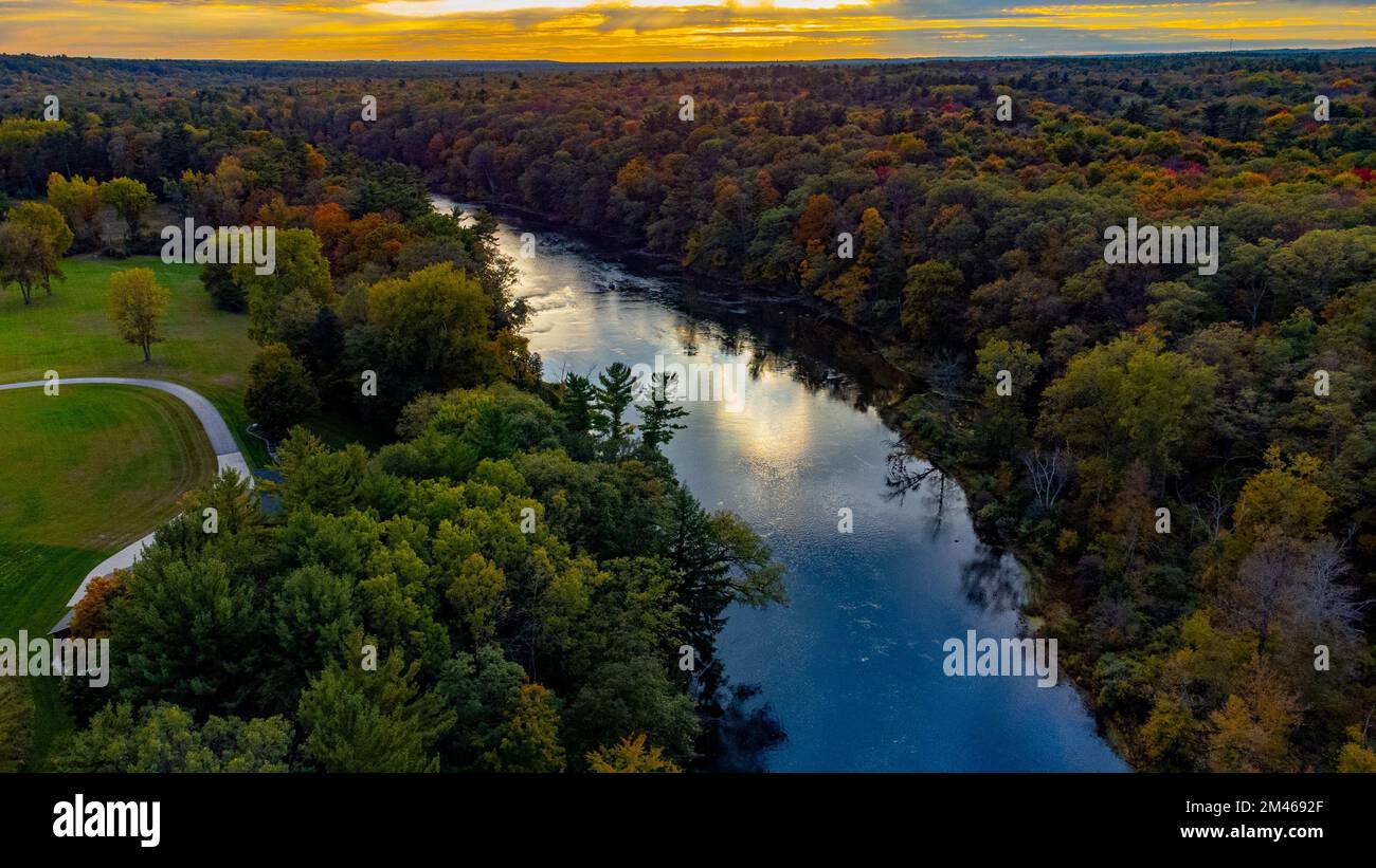 An aerial view of river surrounded by dense trees during sunset Stock ...
