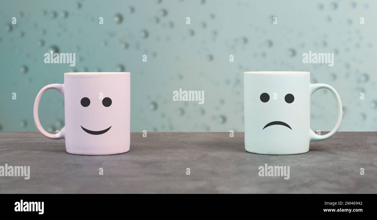 Happy and sad face, cup or mug couple on a window sill, hot drink on a ...