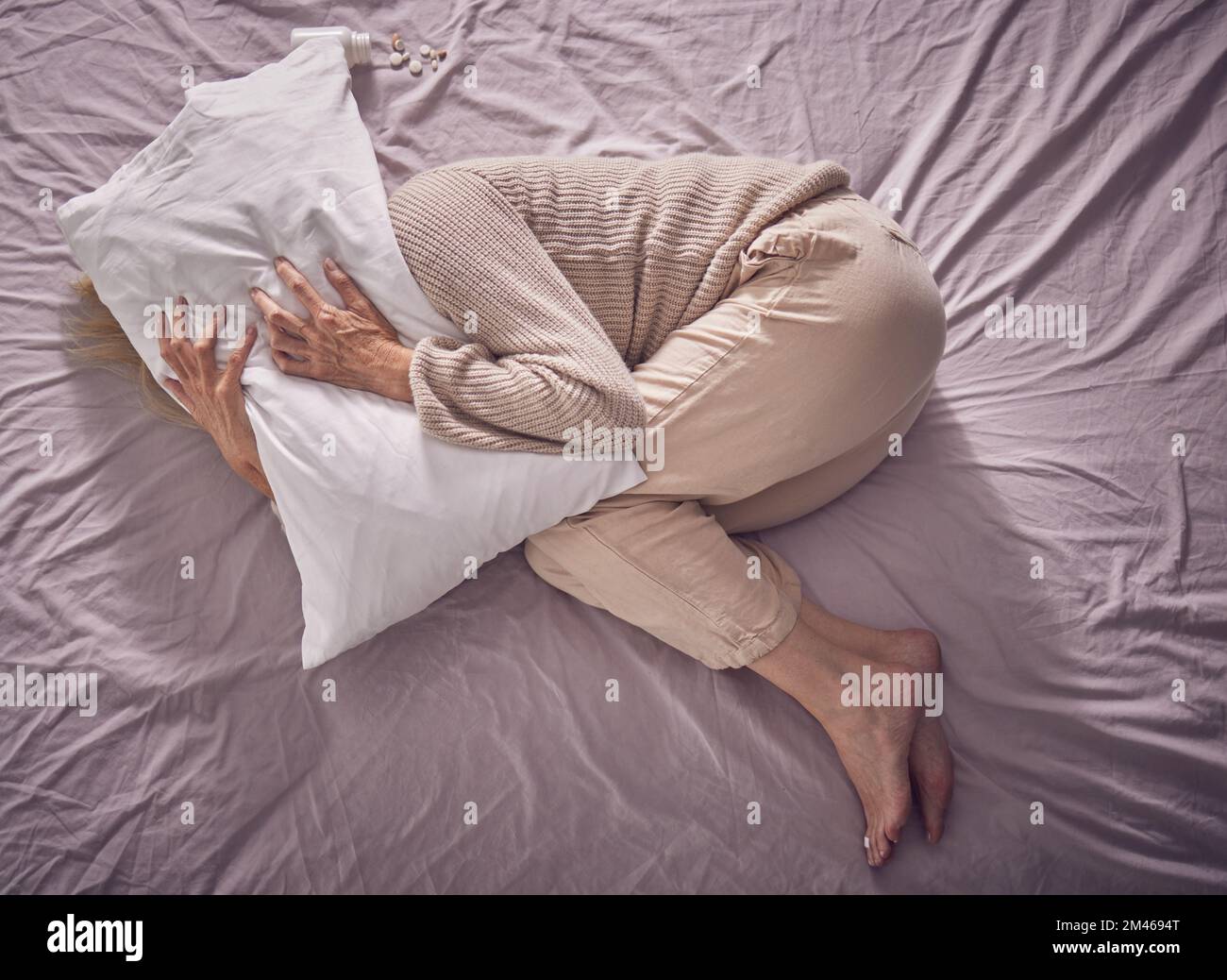 Top view, depression and sad woman with pillow, bedroom and insomnia ...