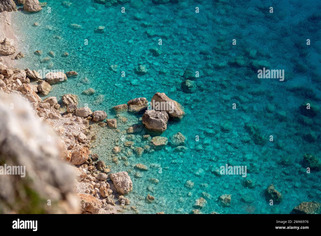 Rocks in deep blue sea Stock Photo - Alamy
