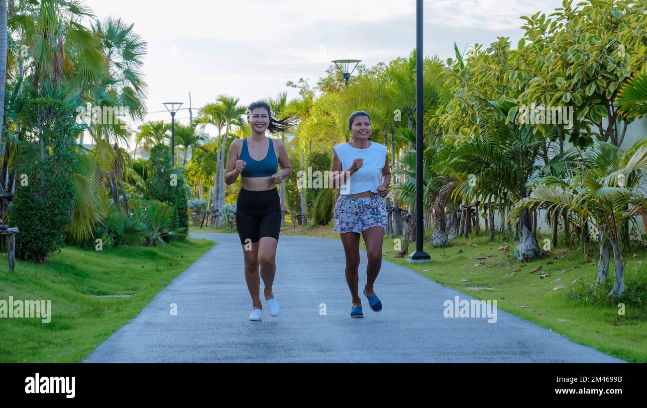 Two Asian Women Exercise Running In A Public Park In Pattaya Thailand