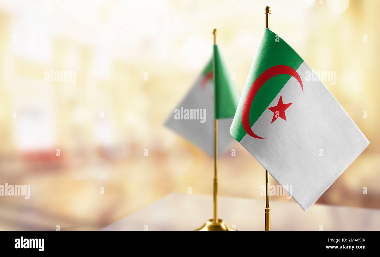 Small flags of the Algeria on an abstract blurry background Stock Photo ...