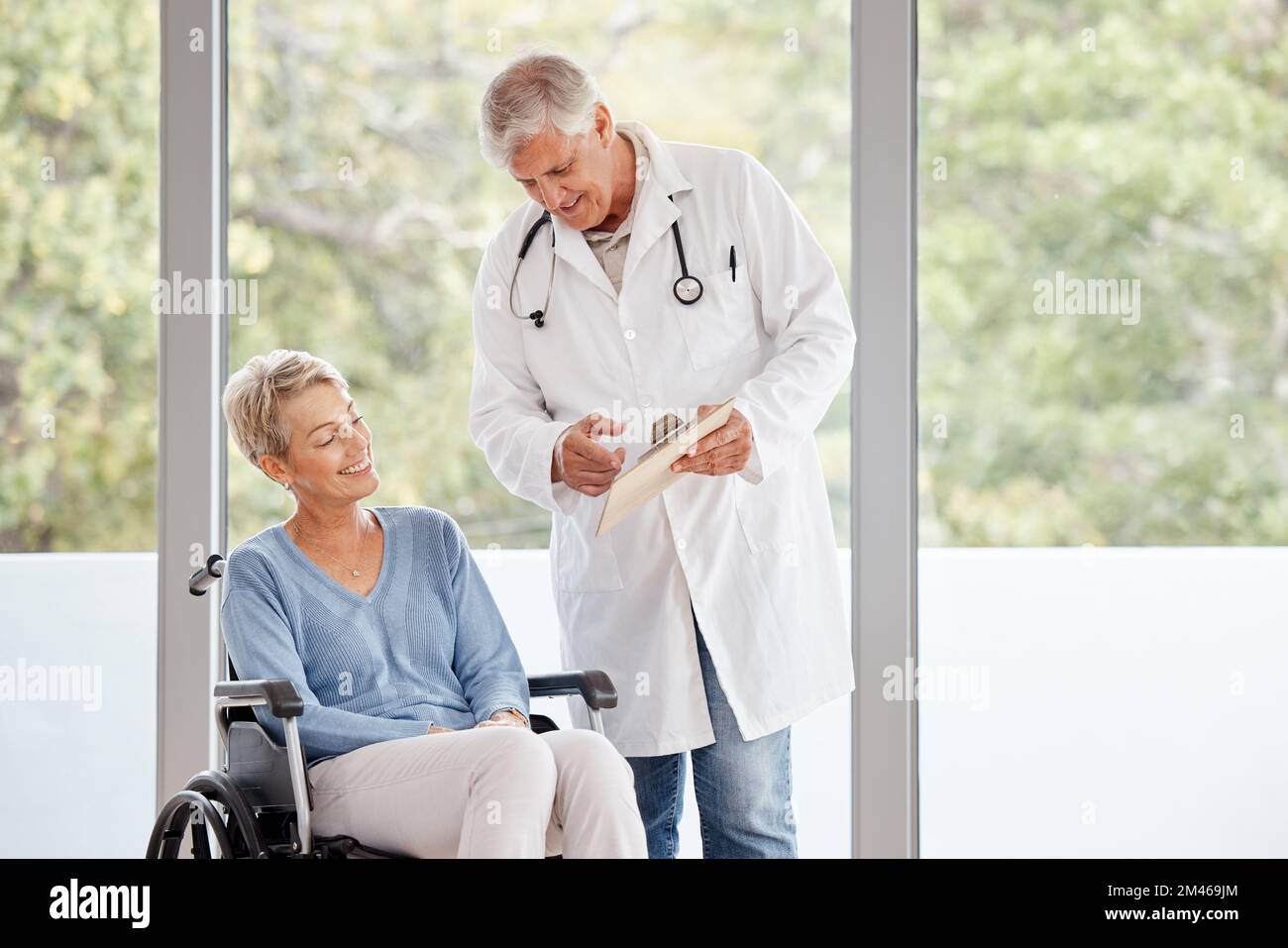 Doctor, consultation and senior patient in wheelchair for healthcare ...