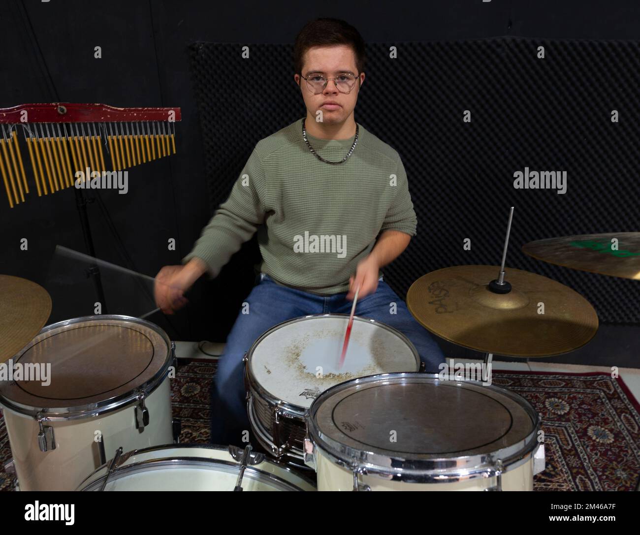 Young man with Down syndrome plays the drums Stock Photo - Alamy