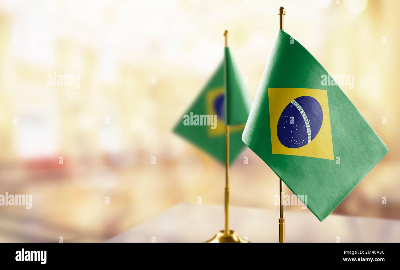 Small flags of the Brazil on an abstract blurry background Stock Photo ...