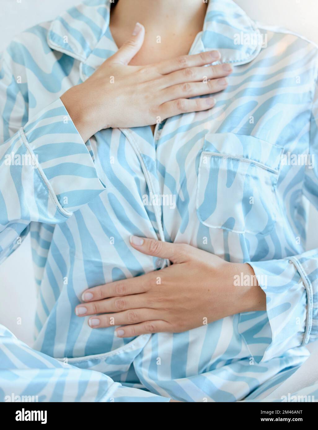 Hands, pajamas and morning with a woman breathing after waking up in ...