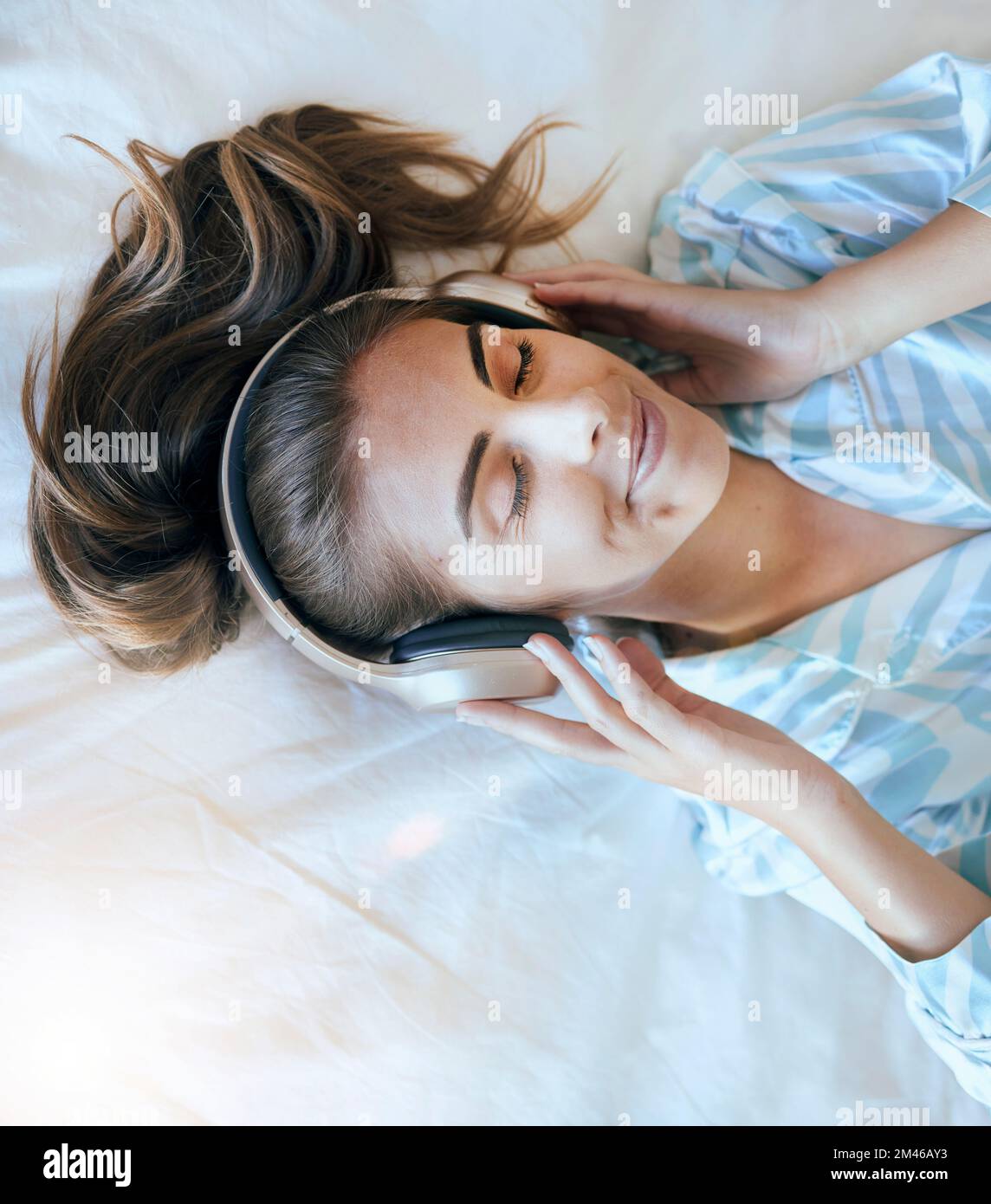 Top view, woman and headphones in bedroom, morning and relax with ...