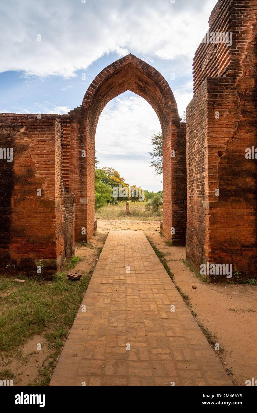 A footpath leads through a brick archway which forms part of an ...