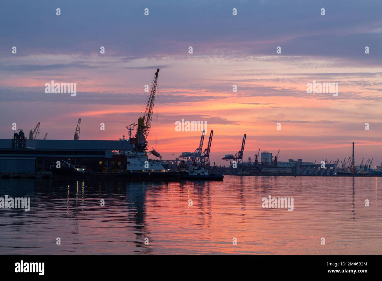 sunset in industrial landscape of commercial seaport. Sunset at seaport ...
