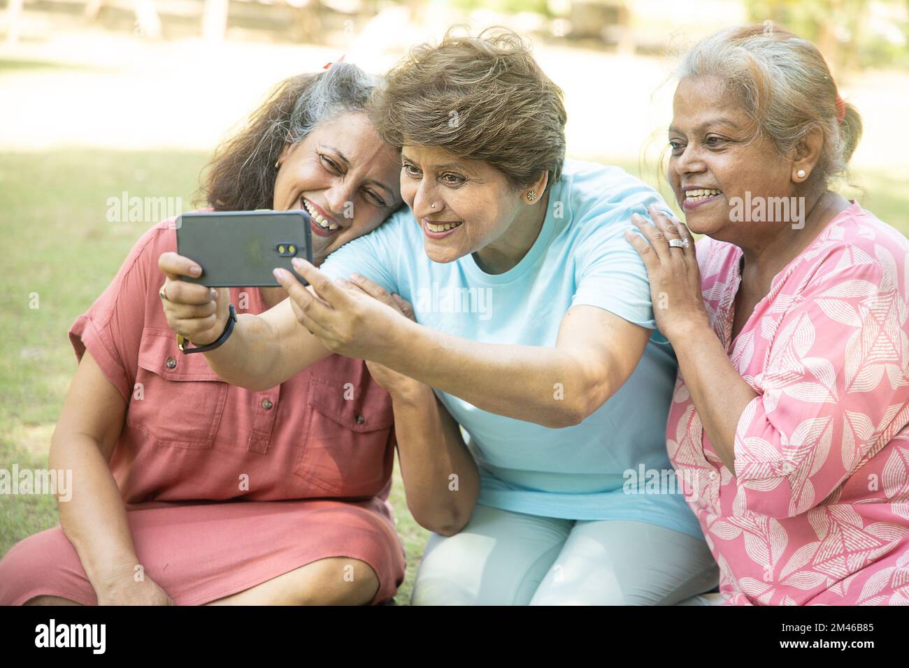 Happy Indian senior women using smart phone and taking pictures of ...