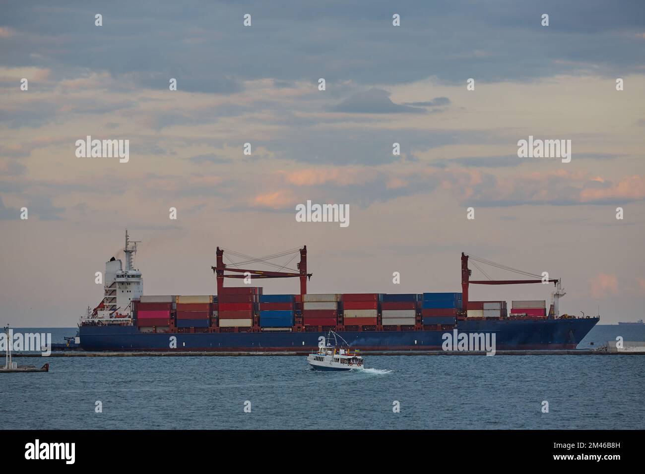 A large merchant ship container vessel in coastal waters of ocean. A ...