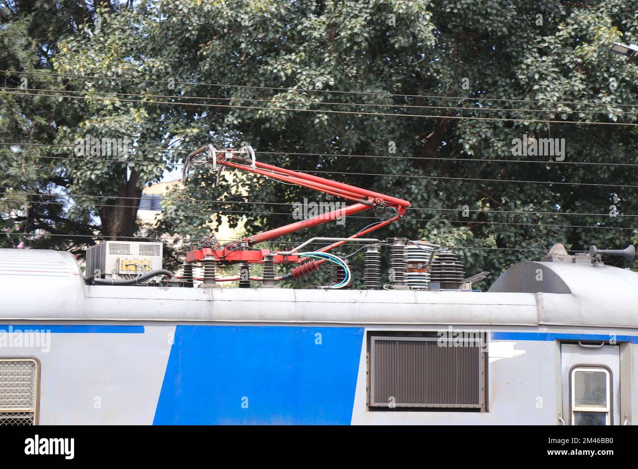 Modern pantograph installed on a regular commute railway train ...
