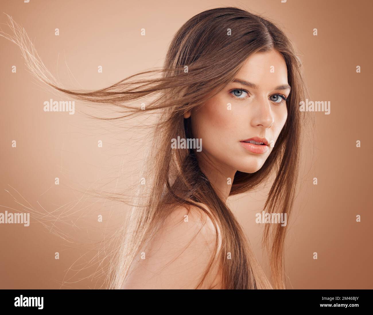 Woman, face glow or windy hair on studio background in keratin treatment, dermatology health ...