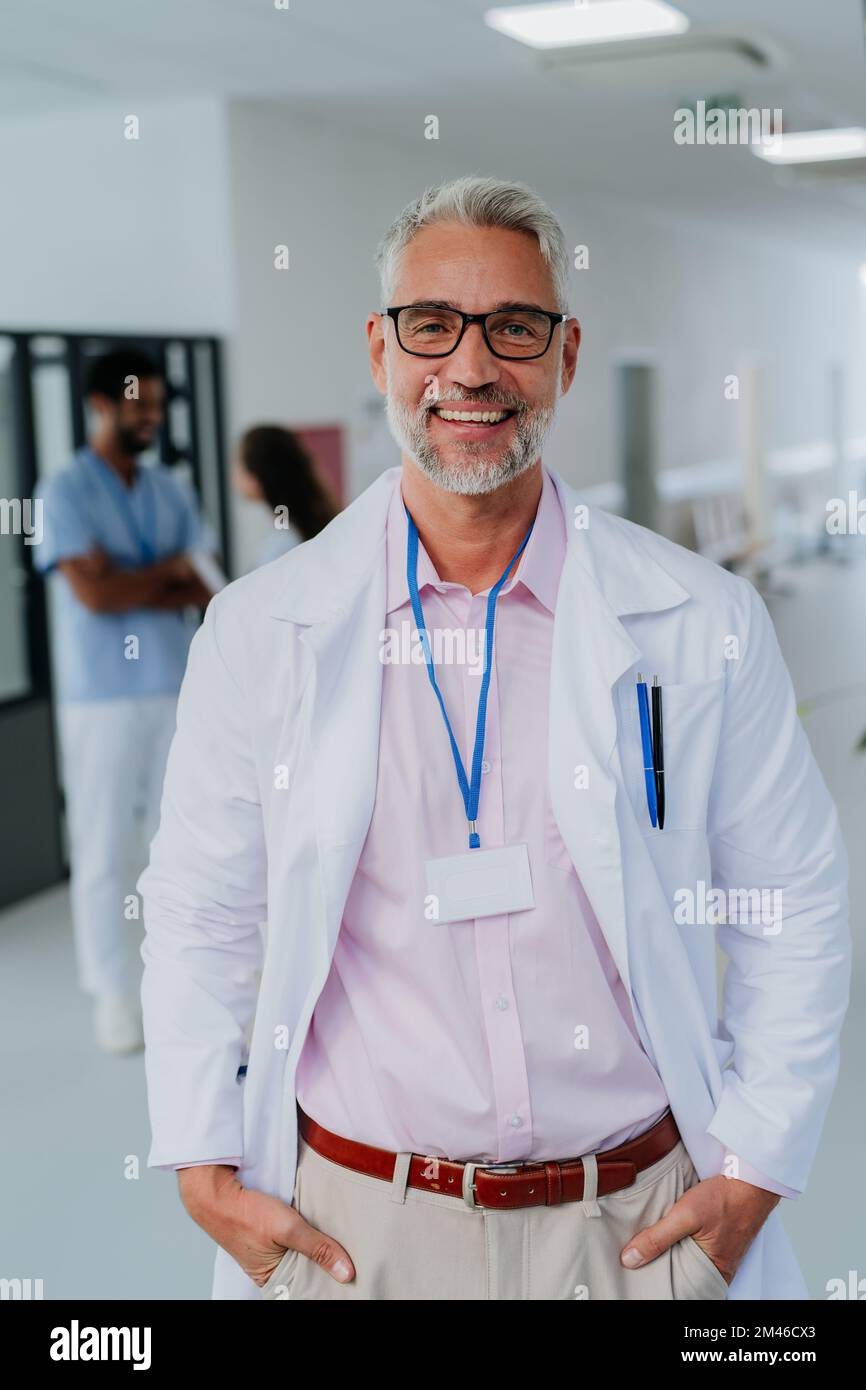 Portrait of happy doctor at hospital corridor Stock Photo - Alamy