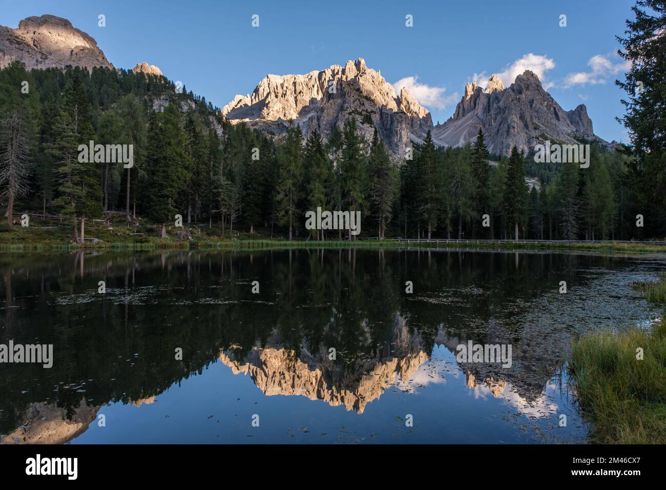 Fantastic panoramic view of the Antorno lake with blue sky at sunset in ...