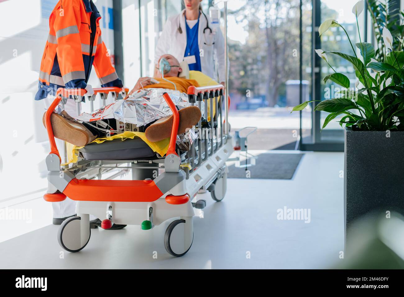 Rescuer bringing patient with serious injury to hospital Stock Photo ...