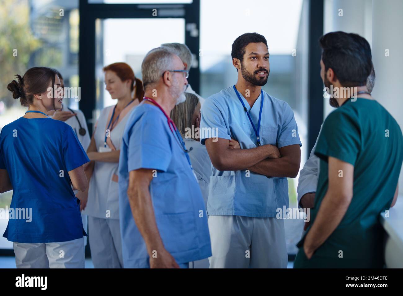 Doctors and nurses talking together at hospital corridor Stock Photo ...
