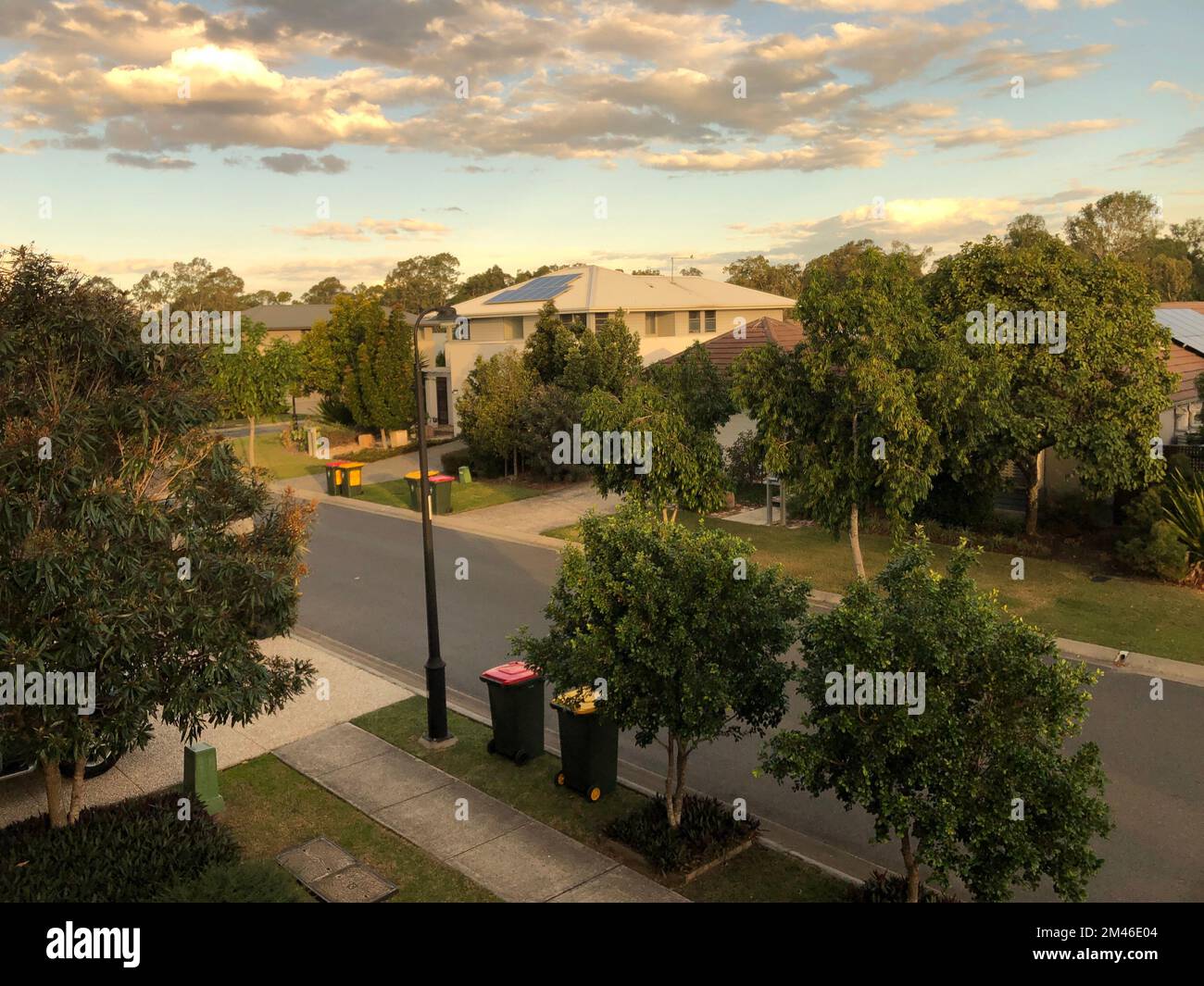 An empty street in the middle of buildings surrounded by trees Stock ...