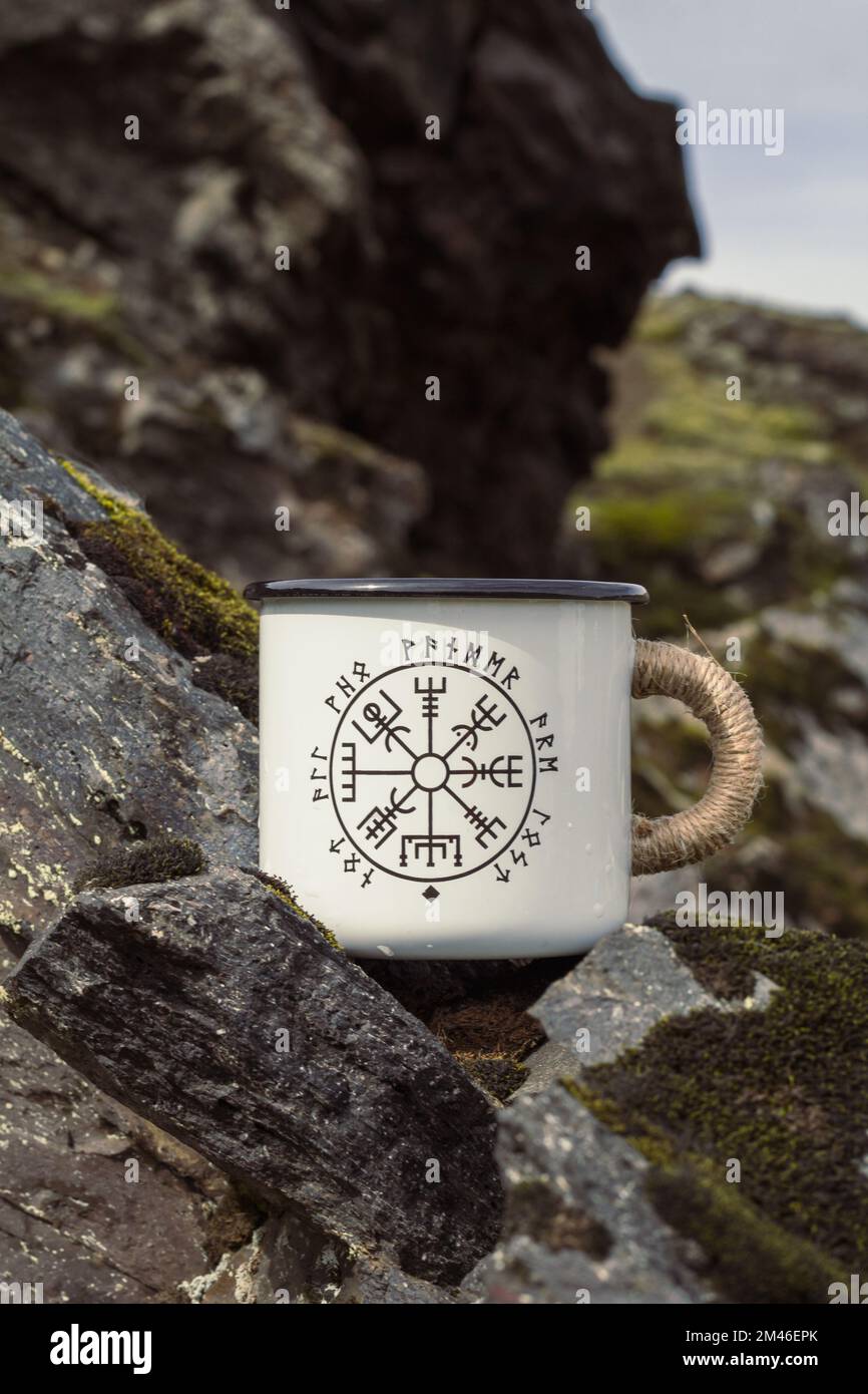 Close up metal cup with runes on rock concept photo Stock Photo - Alamy