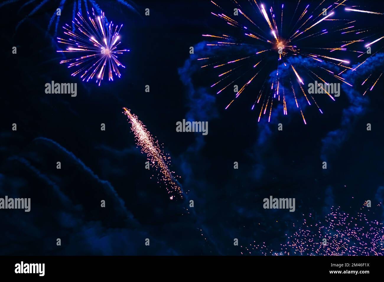 Bright, beautiful blue fireworks in the night sky Stock Photo - Alamy