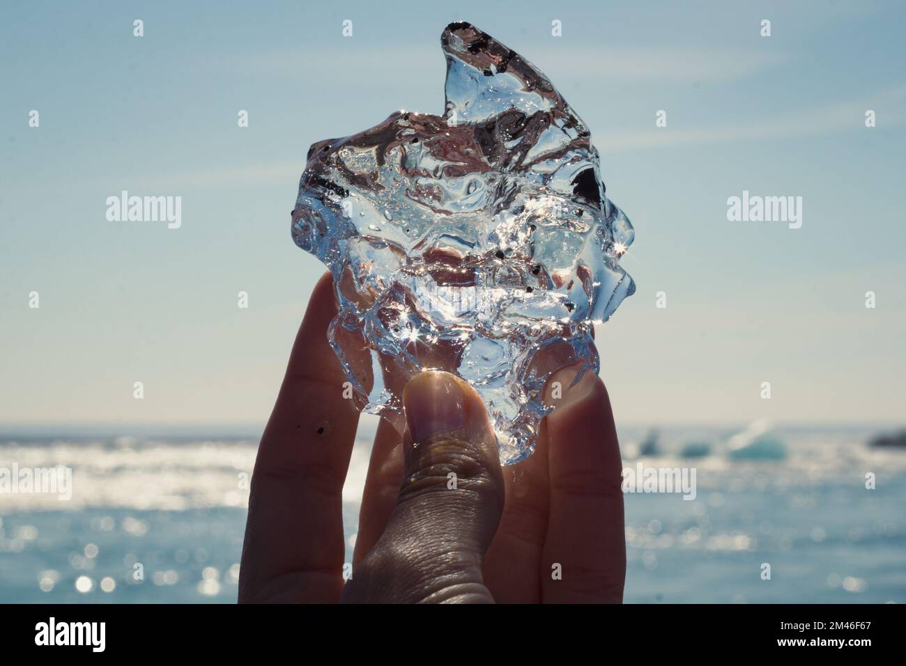 Close up man holding ice on beach concept photo Stock Photo - Alamy