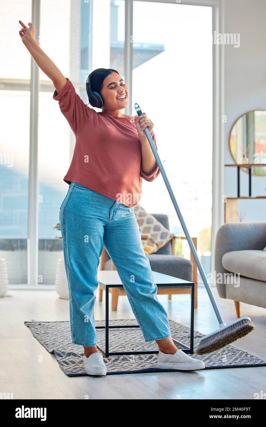 Woman Singing And Dancing While Cleaning Living Room For Fun Domestic