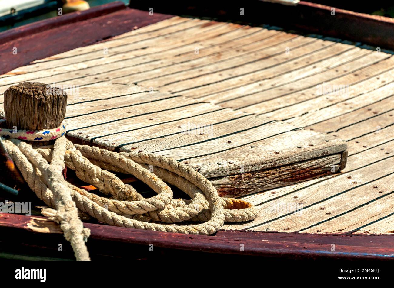 Details of wooden boat bow with forward hatch and some rope Stock Photo ...