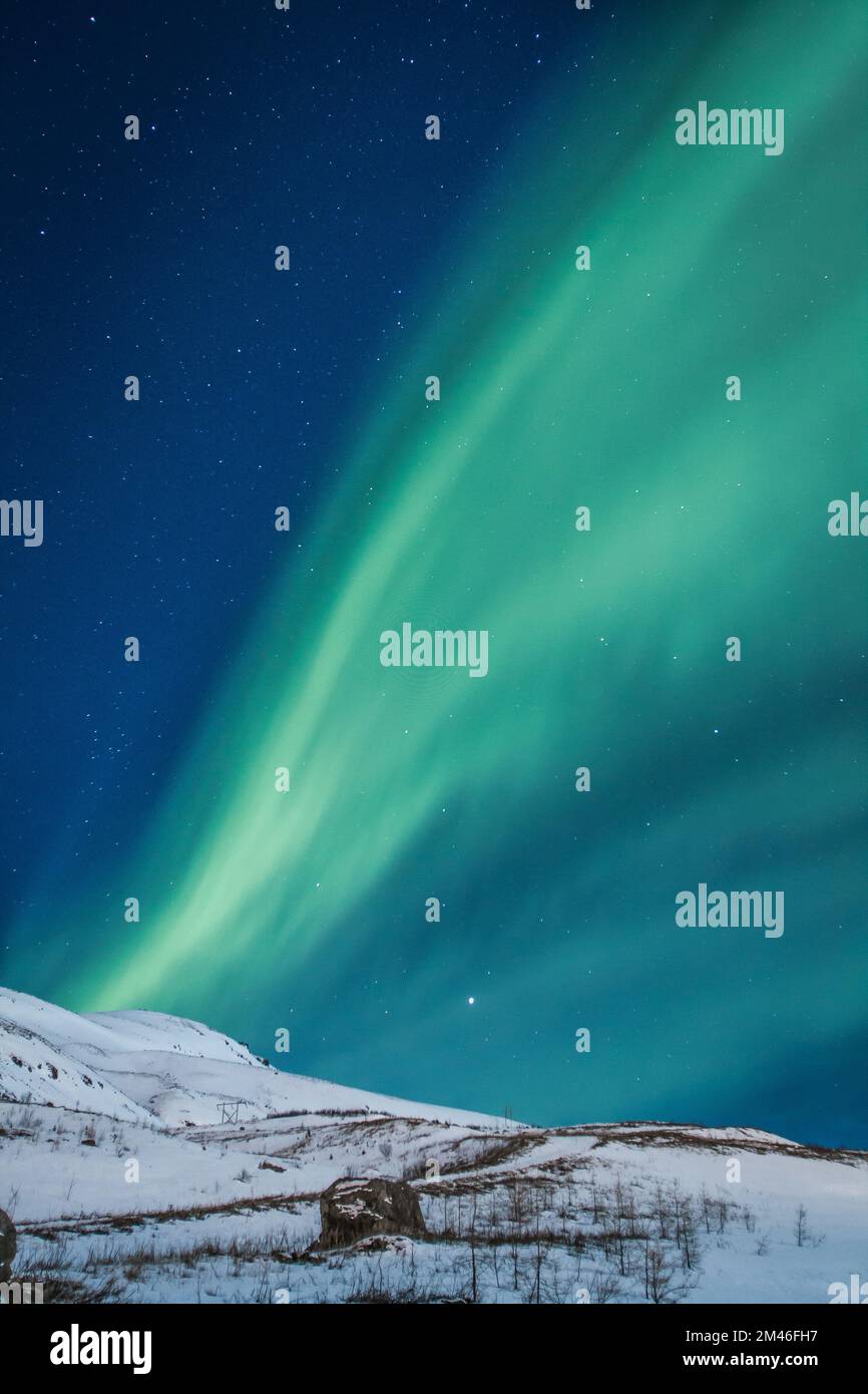 Snowy hills under northern lights landscape photo Stock Photo - Alamy