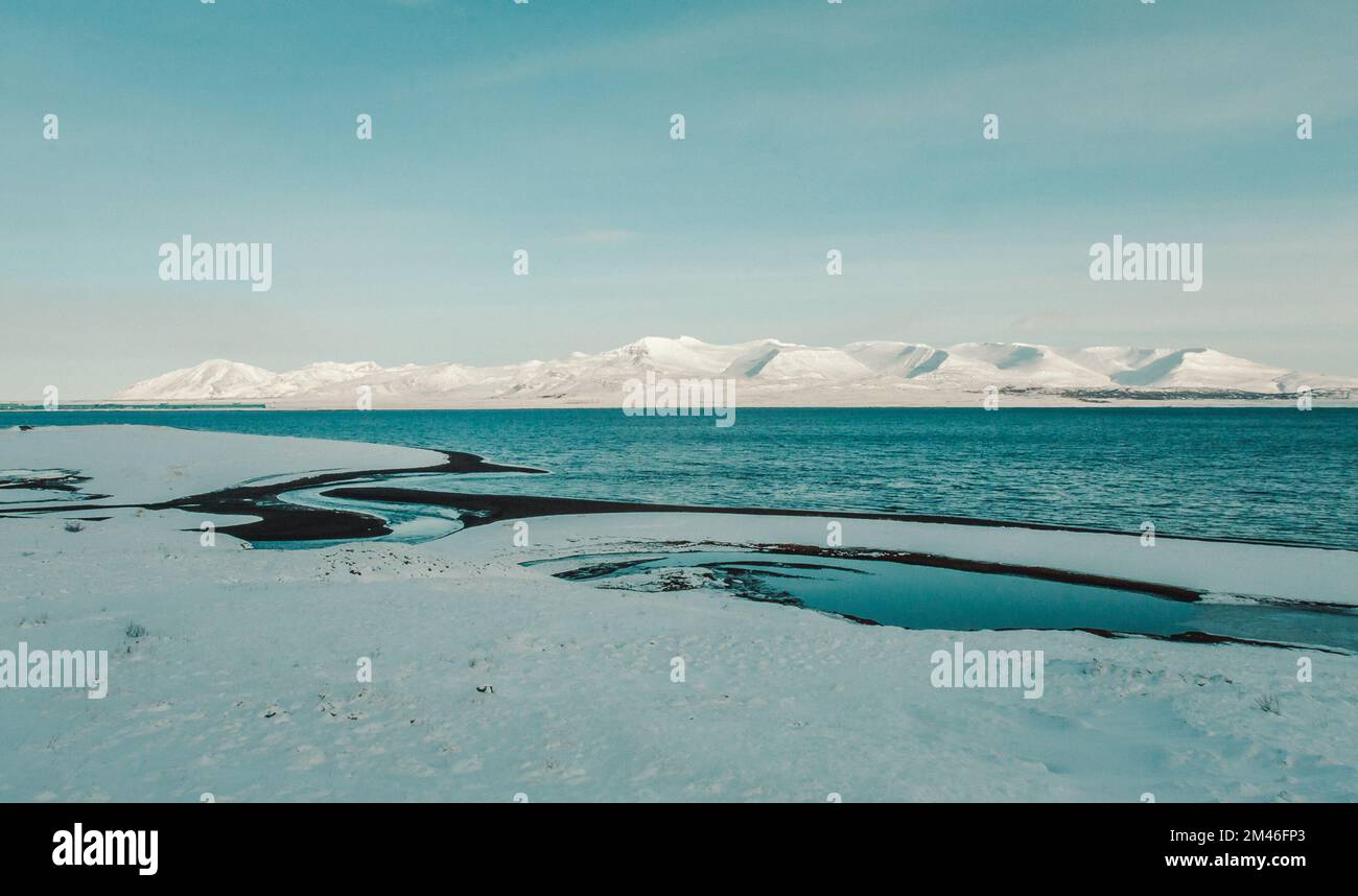 Snowy coast of sea bay landscape photo Stock Photo - Alamy