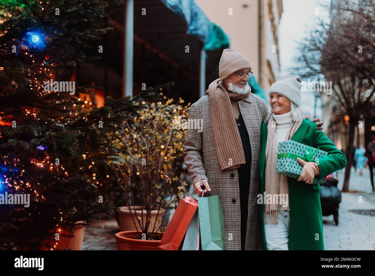 Couple buying christmas decorations at christmas market hi-res stock ...