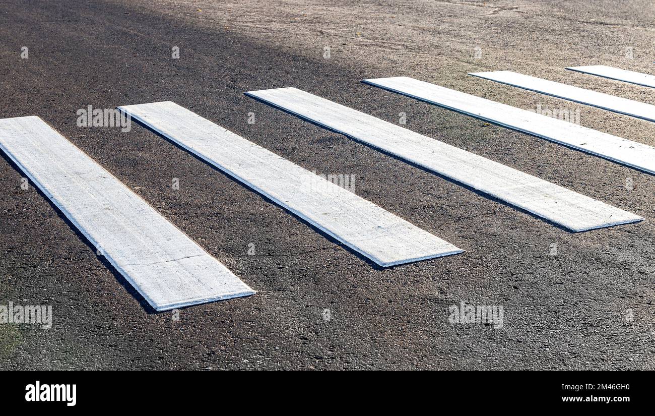 Pedestrian crossing with white stripes on the asphalt. Crosswalk on the ...