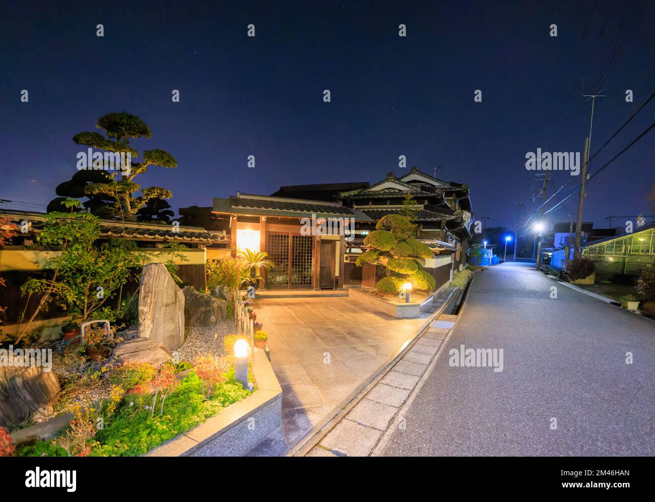 Traditional Japanese house and garden on quiet street at night Stock ...