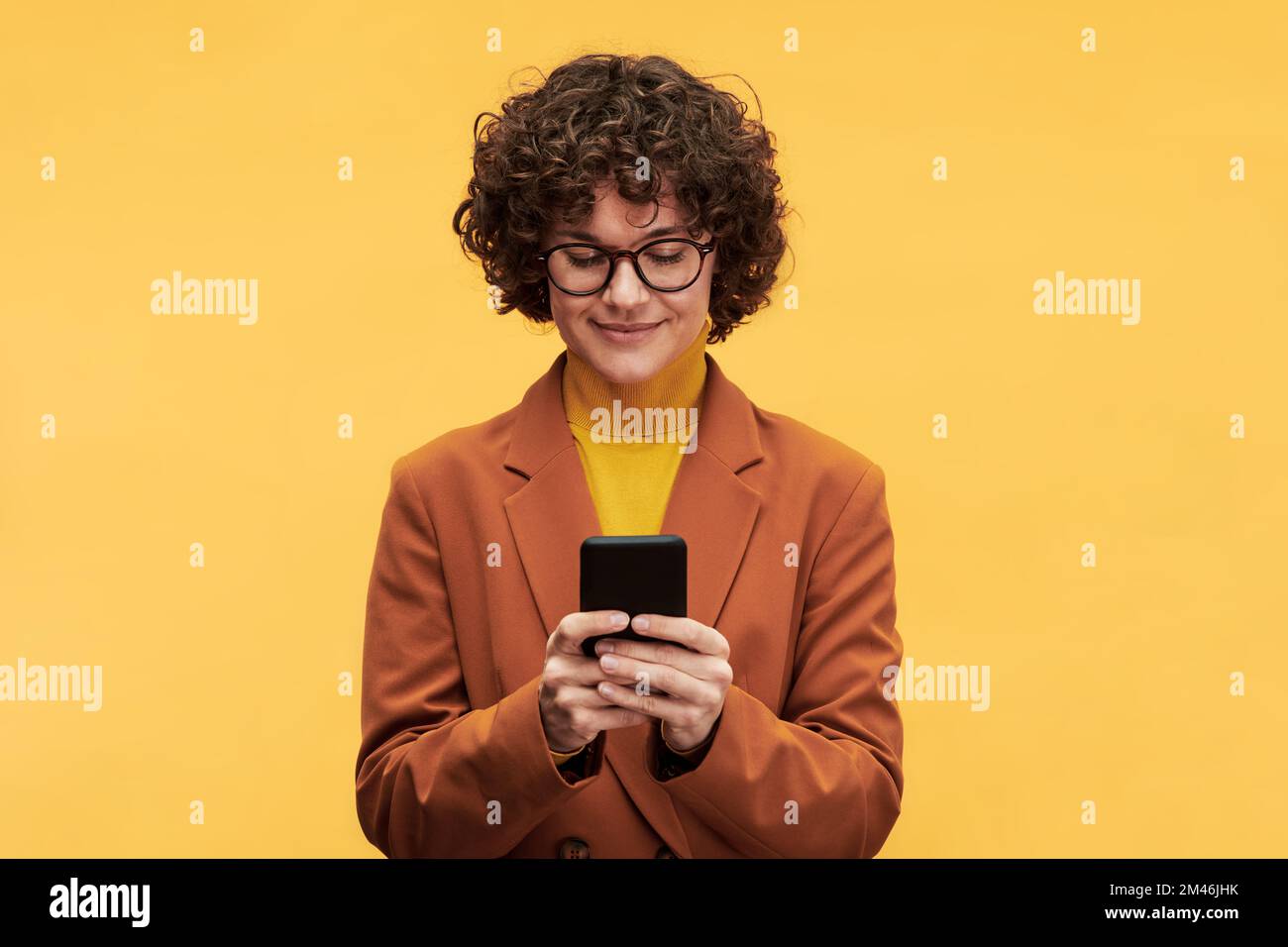 Young woman with short dark curly hair scrolling through online goods ...