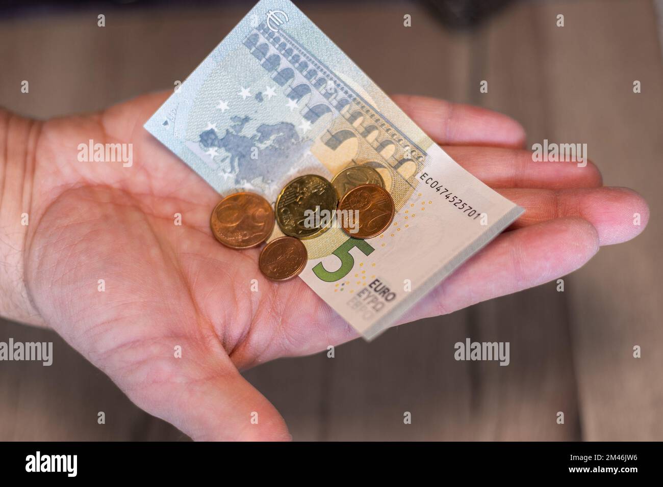 Hand holding few euro hi-res stock photography and images - Alamy