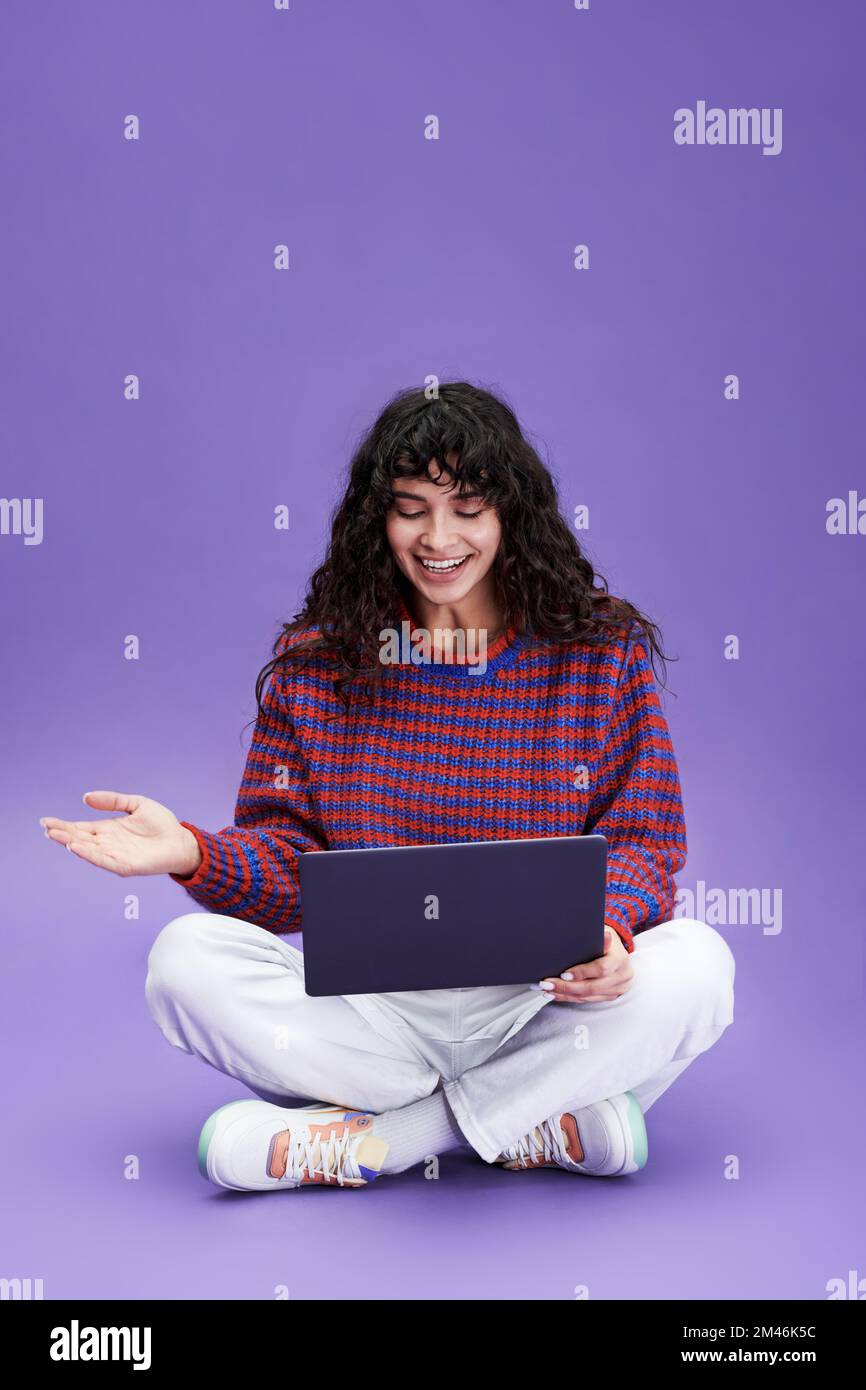 Happy girl with dark long wavy hair communicating in video chat while ...
