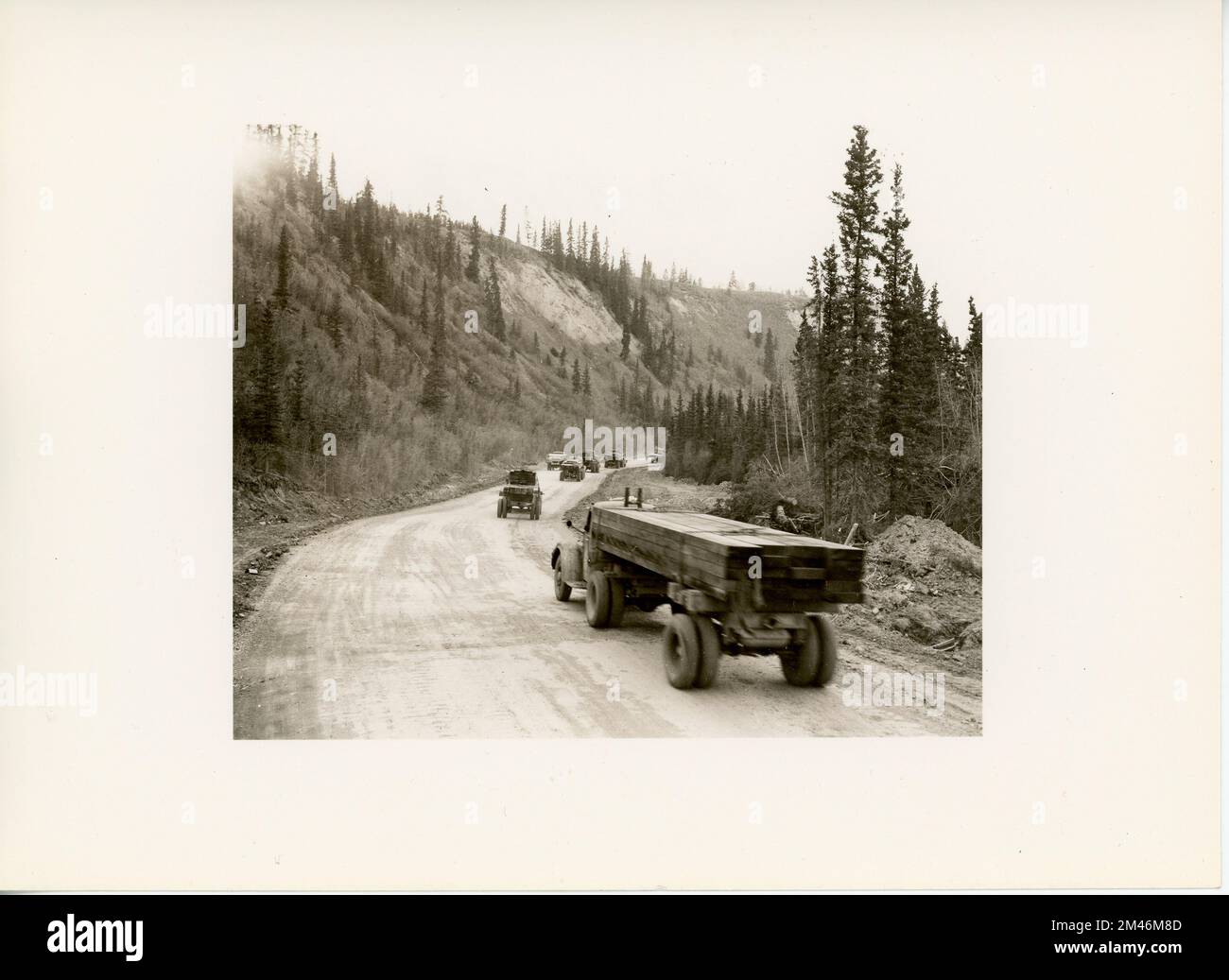 The Alaska Highway. Original caption: Trucks operated by Dowell ...