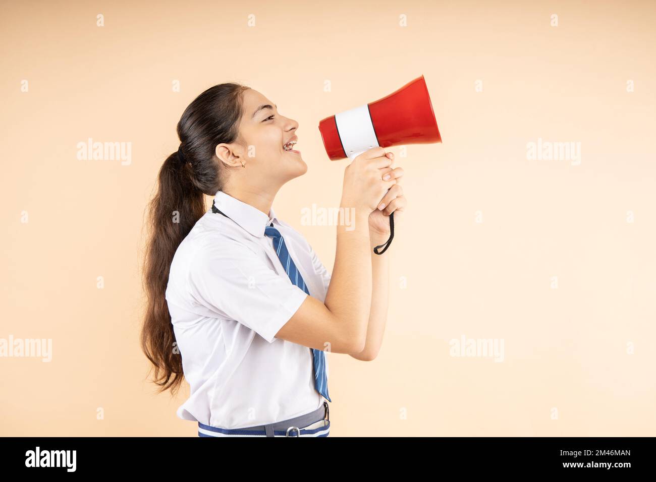Happy Excited Indian student schoolgirl wearing school uniform hold ...