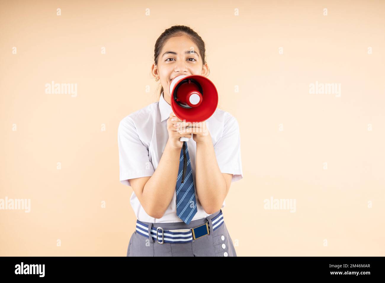 Happy Excited Indian student schoolgirl wearing school uniform hold ...