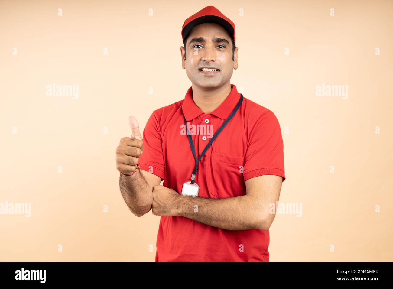 Portrait of indian courier man or delivery boy wearing red t-shirt and ...