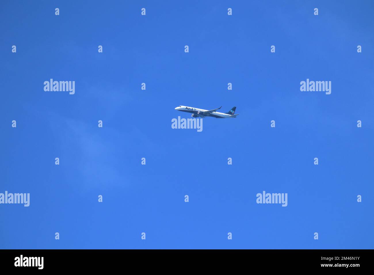 Distant passenger jet plane flying on high altitude on clear blue sky ...
